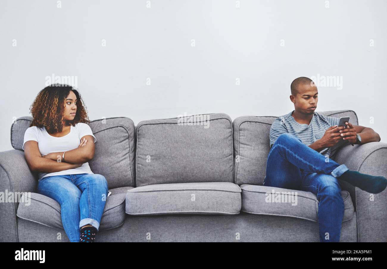 Who is he giving all his attention to if not me. a young man texting on ...