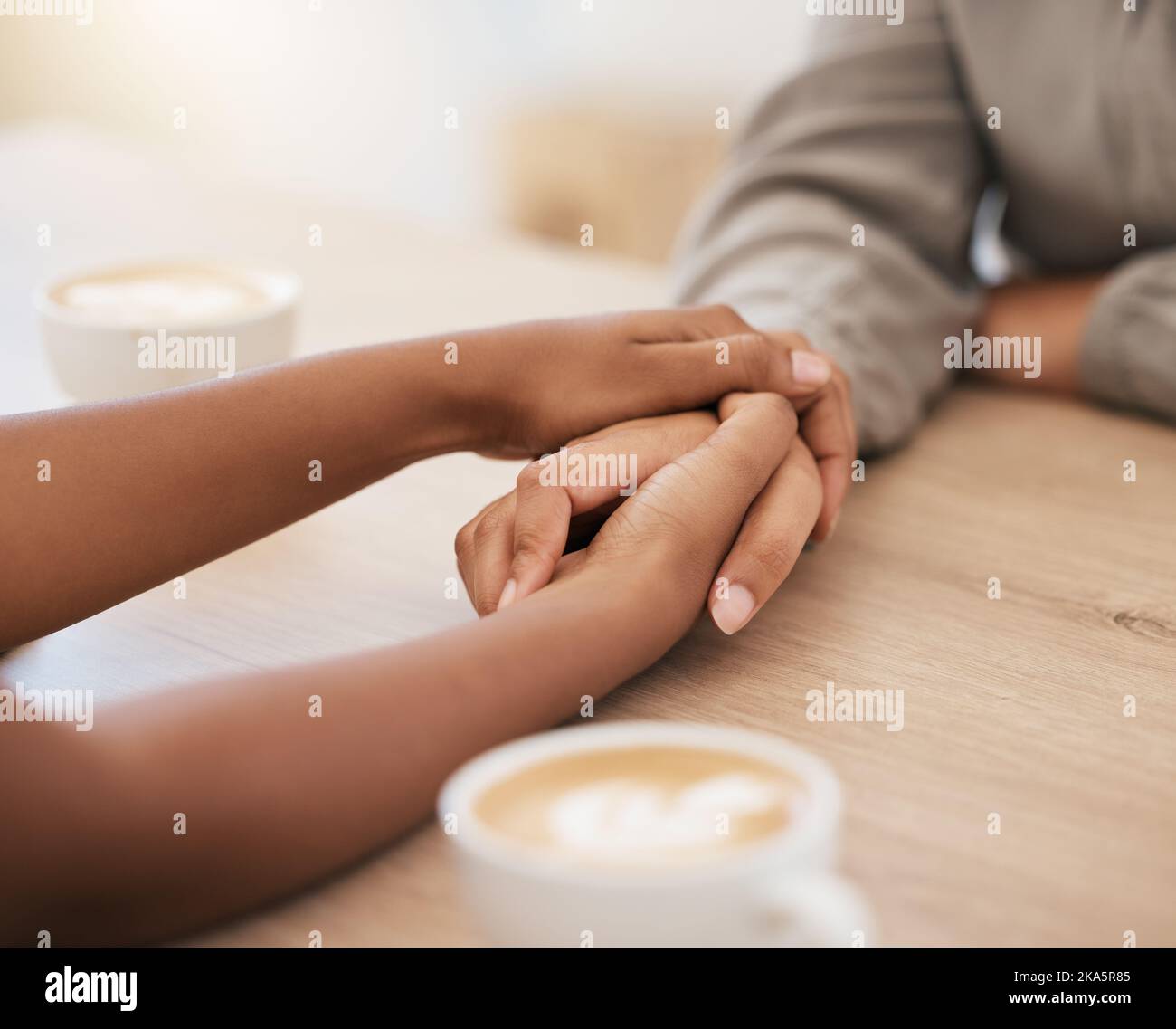 Coffee, women and holding hands in support, trust or help for mental ...