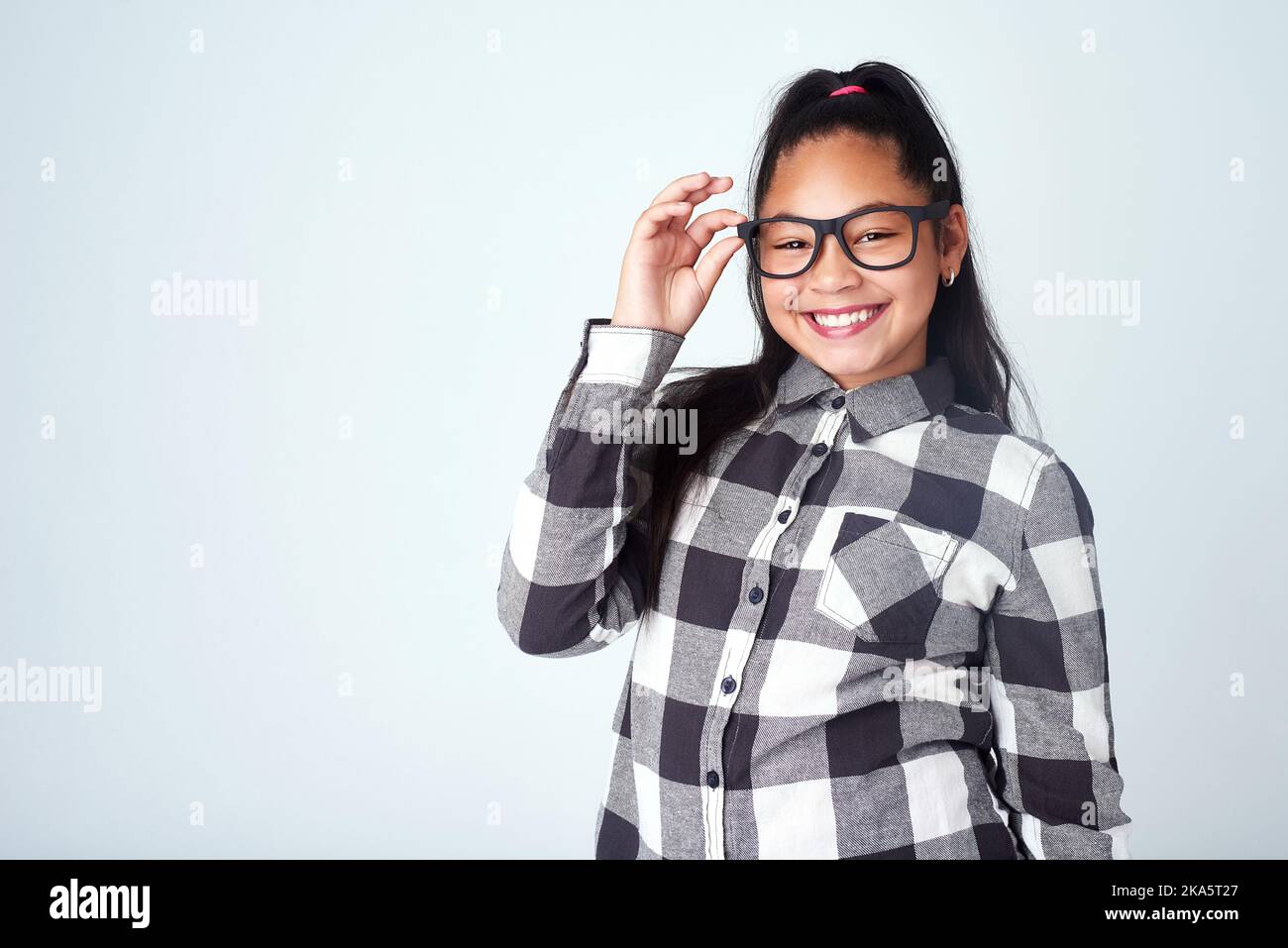 The perfect frames for my face. Studio portrait of a cute and confident young girl posing ...
