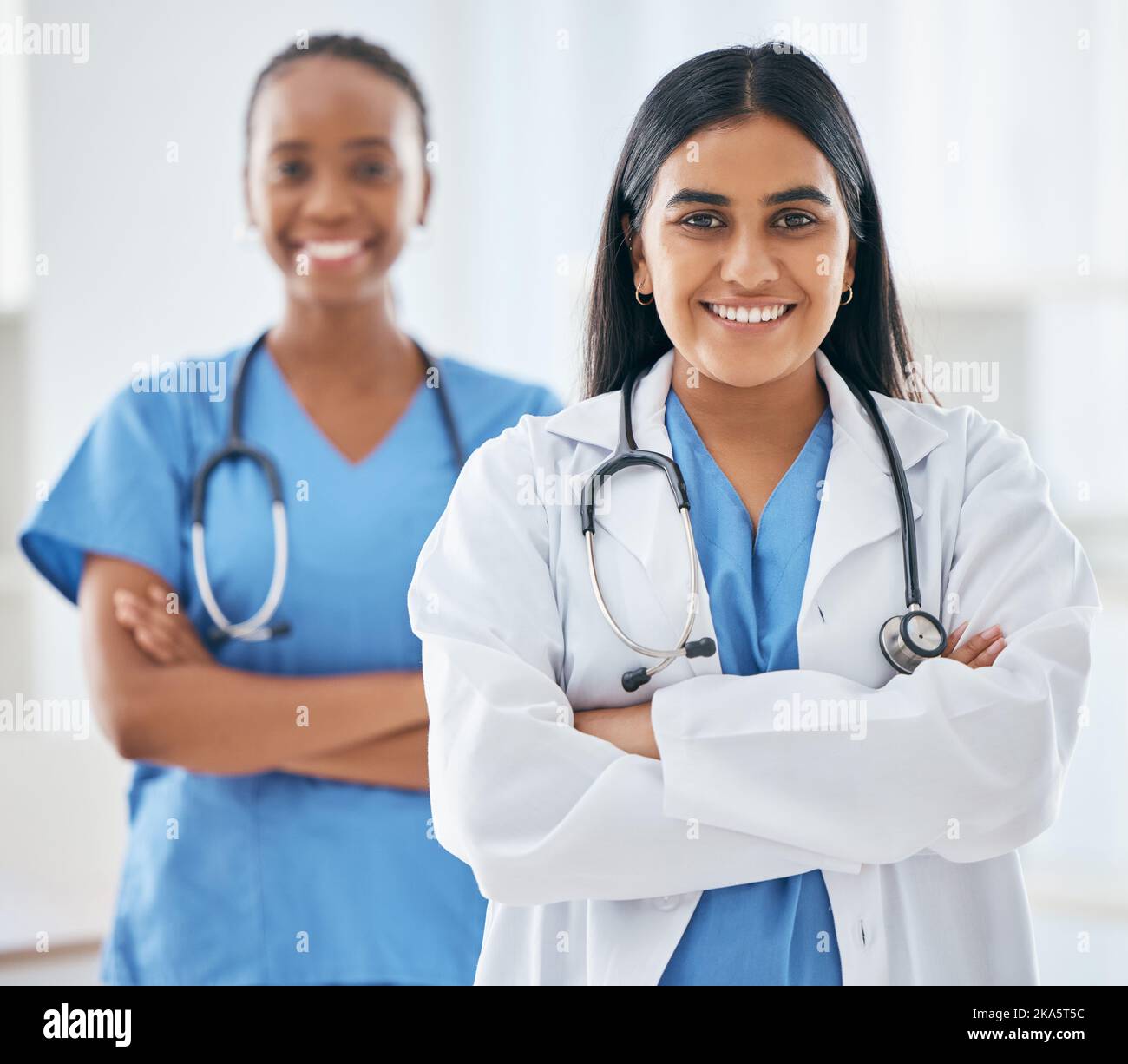 Happy, portrait and women doctors in collaboration standing with crossed arms in hospital ...