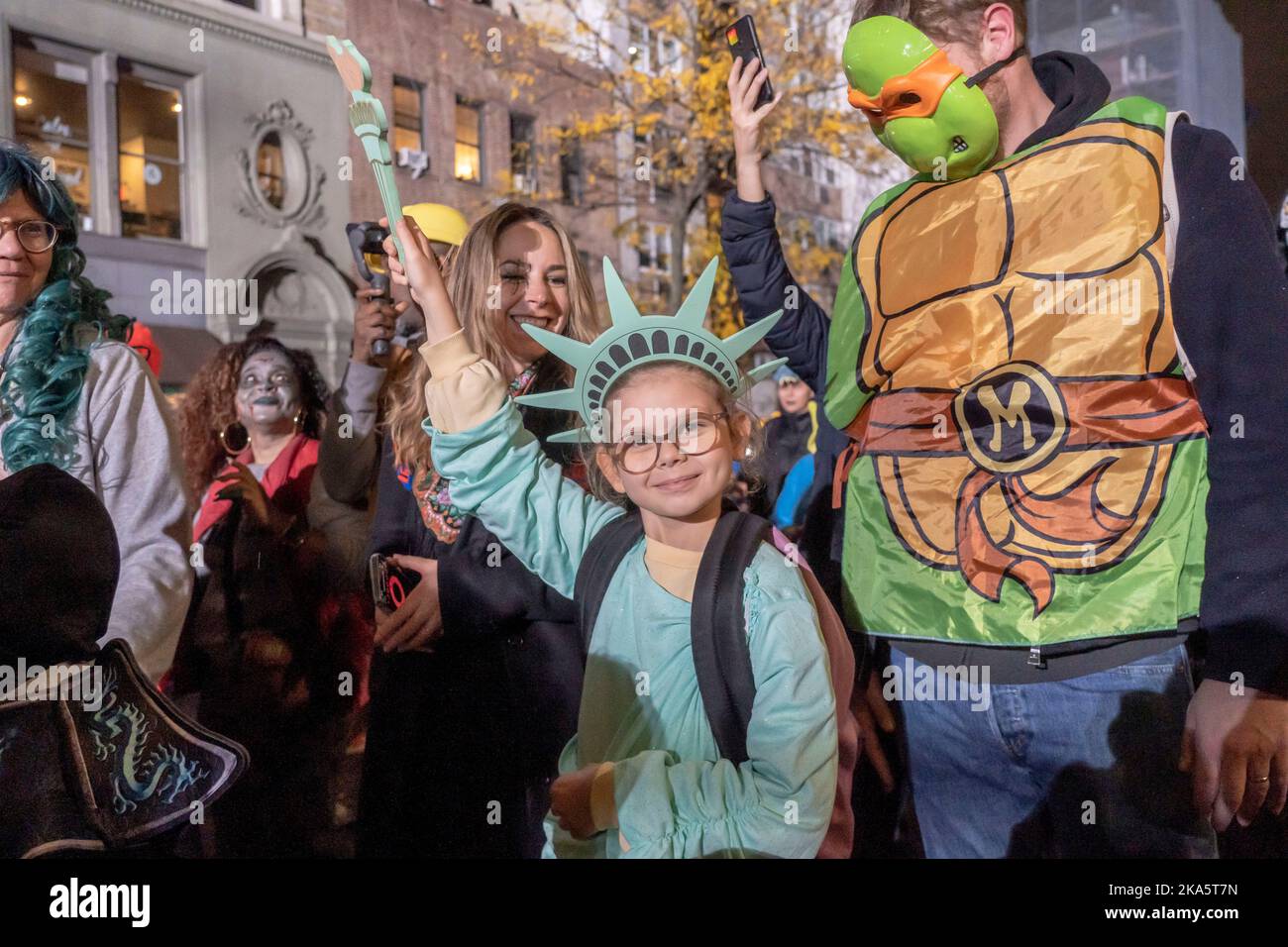 NEW YORK, NY - OCTOBER 31: Revelers dressed in costume participate in ...