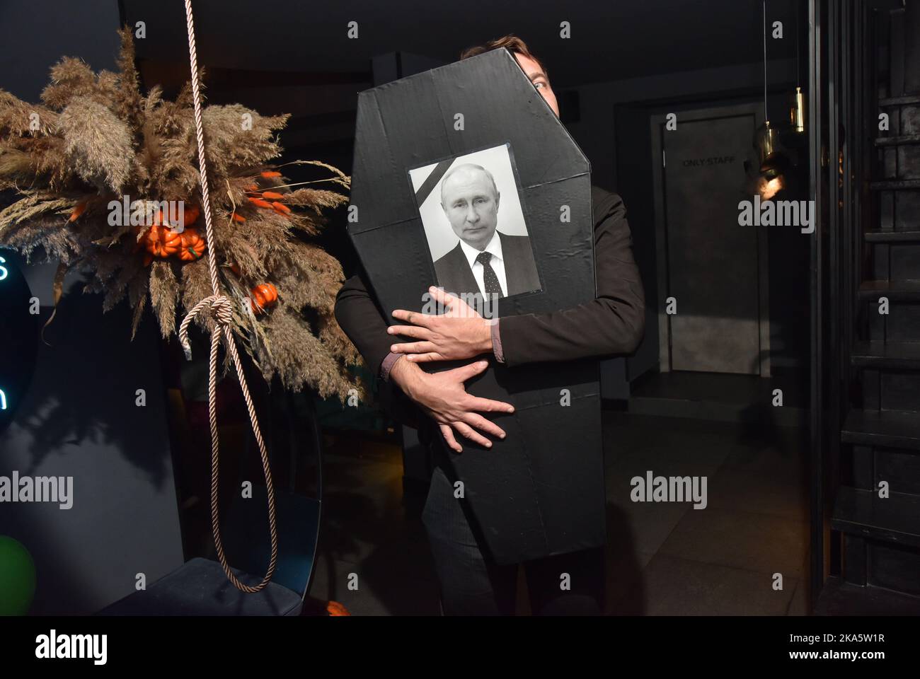 Lviv, Ukraine. 31st Oct, 2022. A man hugs a coffin with a portrait of ...