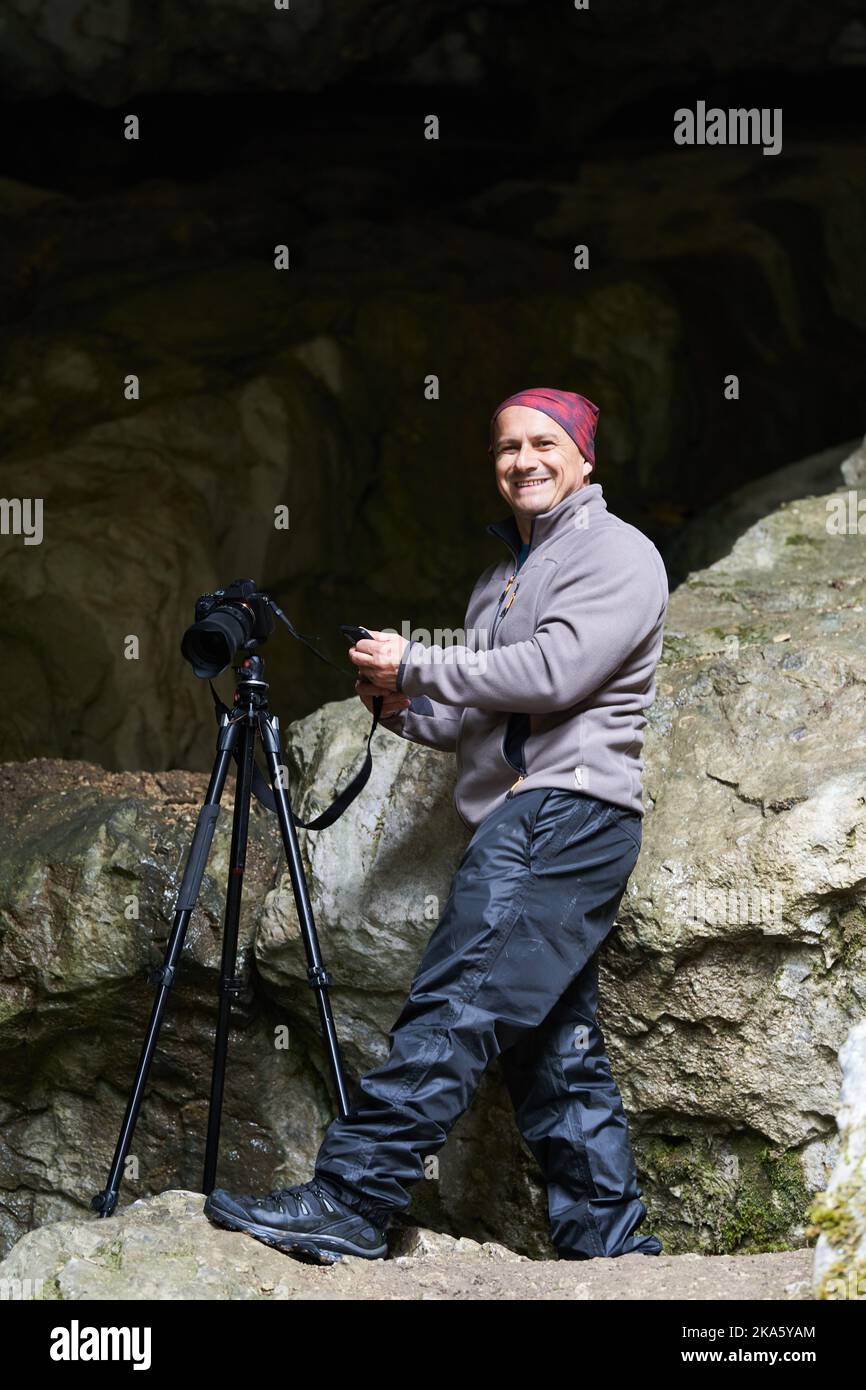 Nature photographer with camera on a tripod, shooting landscapes in a ...