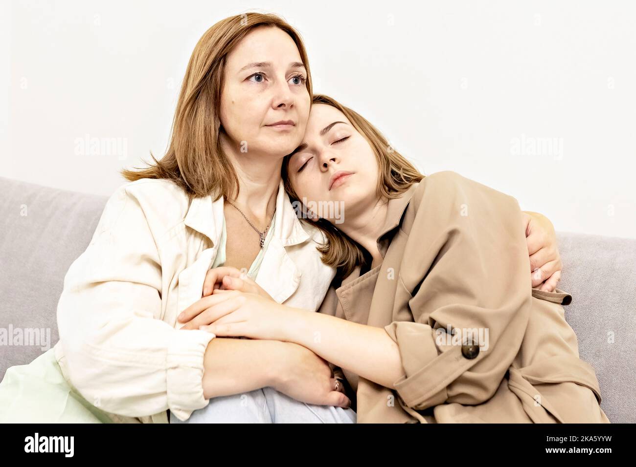 Parents and teens.Mom and teenage daughter are sitting on the couch ...
