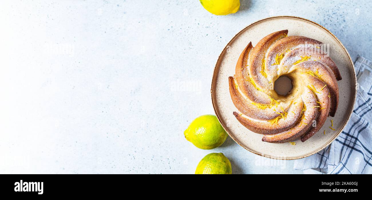 Traditional lemon cake on a cake stand, gray background, top view, copy ...