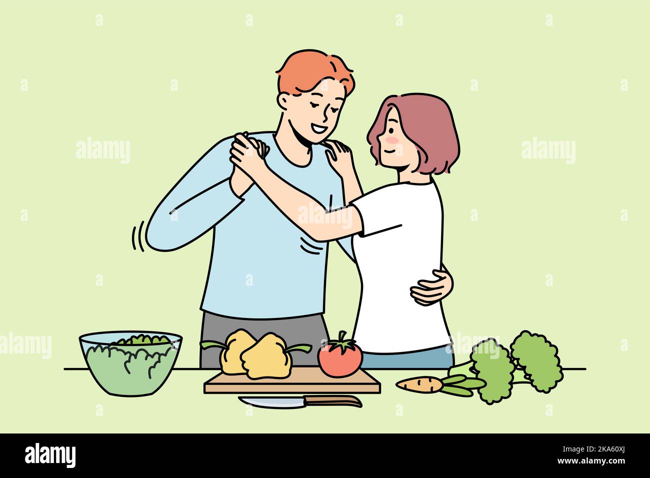 Happy couple cooking in kitchen dancing together. Smiling man and woman ...