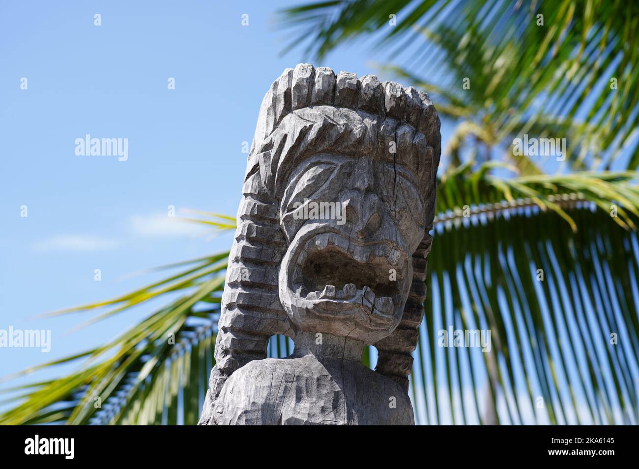 Wooden figure with angry face on historic site at Big Island Hawaii ...