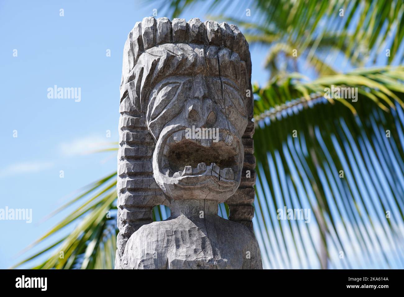 Wooden figure with angry face on historic site at Big Island Hawaii ...