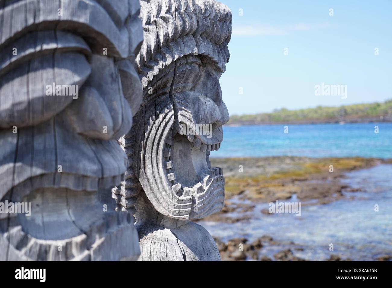 Wooden figure with angry face on historic site at Big Island Hawaii ...