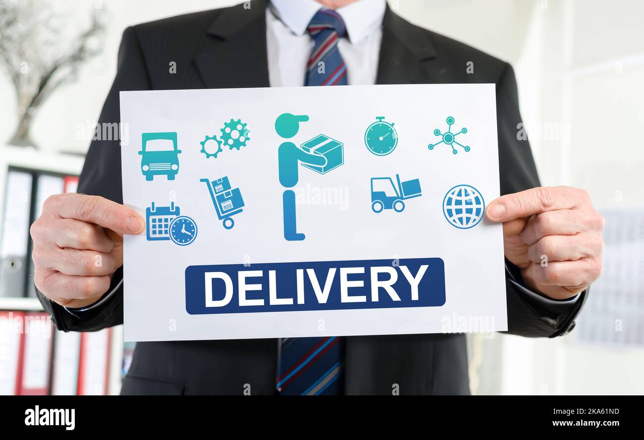 Paper showing delivery concept held by a businessman Stock Photo - Alamy