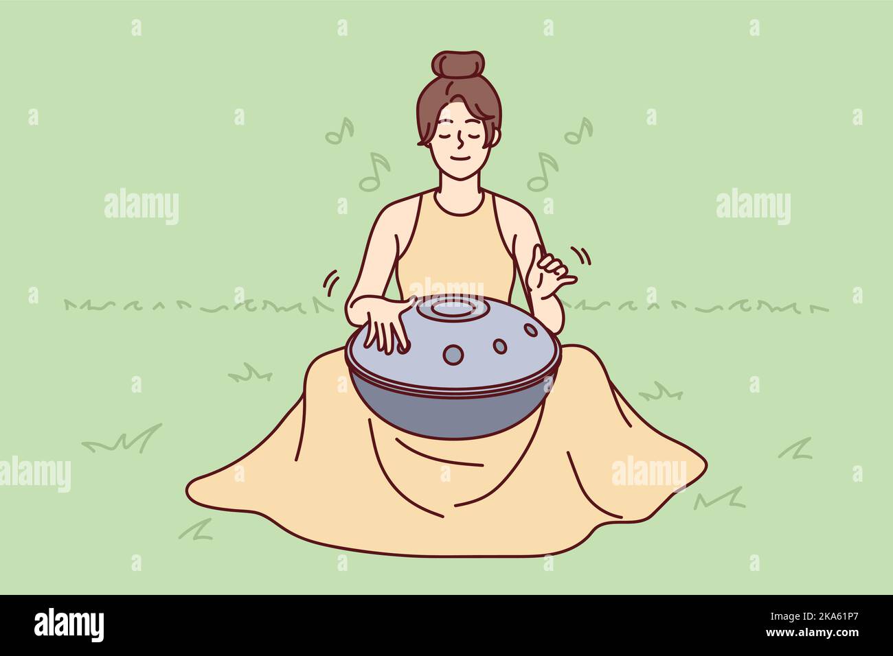 Young woman sit on grass outdoors play on traditional musical ...