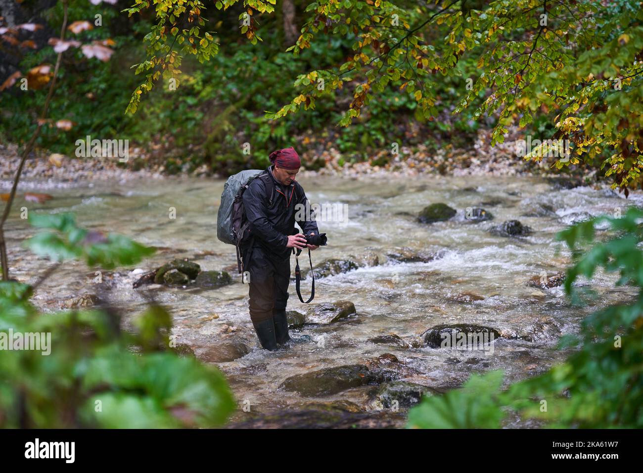 Professional nature photographer shooting landscapes in a canyon with a ...