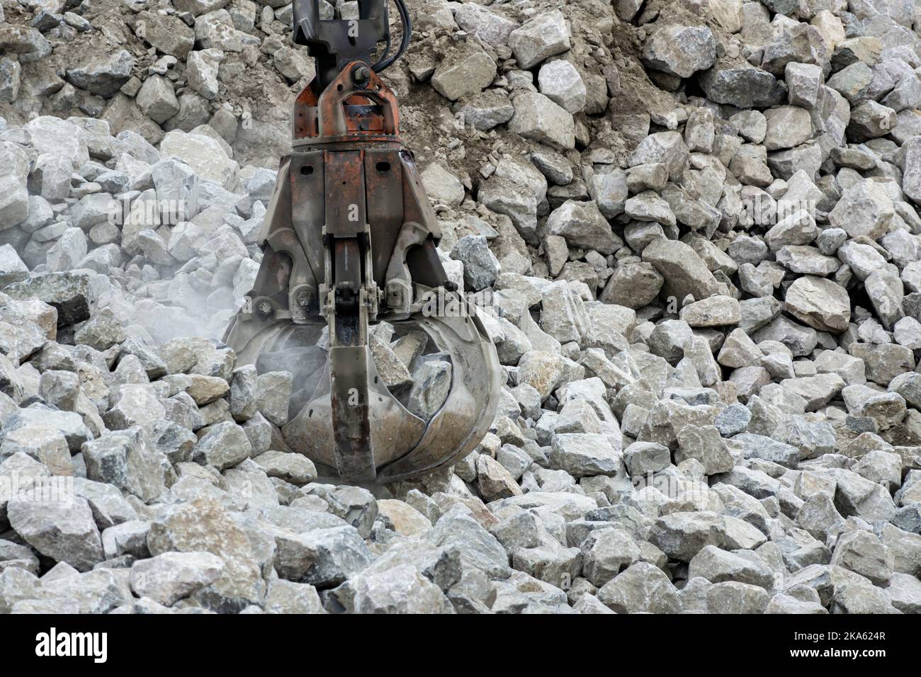 excavator claw moving natural stones for transport Stock Photo - Alamy