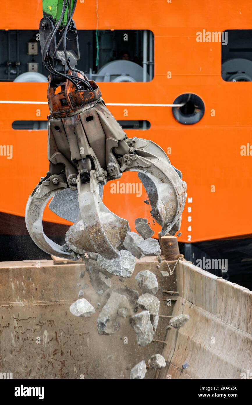 excavator claw moving natural stones for transport Stock Photo - Alamy