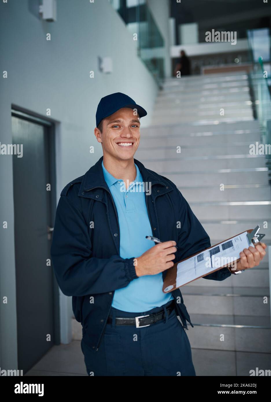 Looking at my checklist for the day. a handsome young man marking off ...