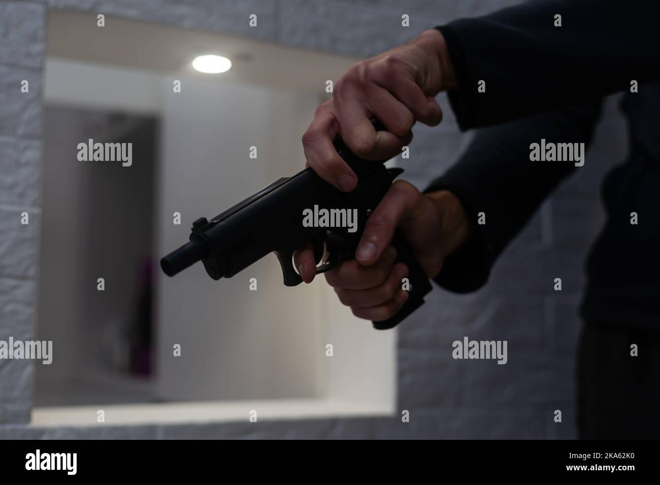 Threat of firearms. Muzzle of gun in man's hand is pointed at camera ...