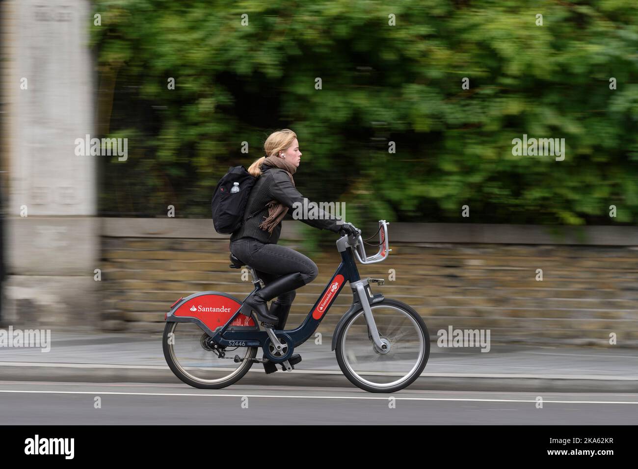 A female cyclist riding a Transport for London Santander Cycles, hire bicycle, commonly know as ...