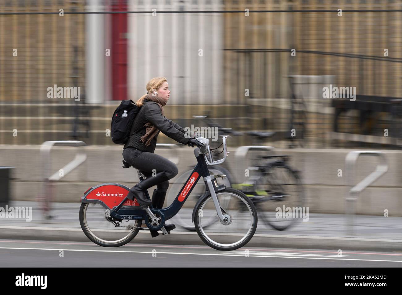 A female cyclist riding a Transport for London Santander Cycles, hire bicycle, commonly know as ...