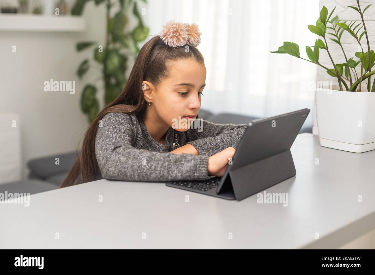 Happy teenage girl watching movies from tablet computer Stock Photo - Alamy