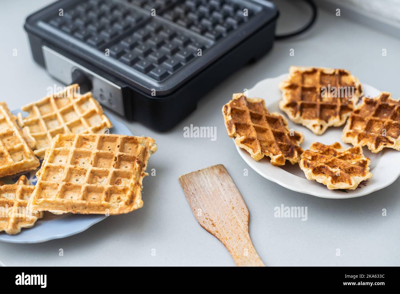 Modern waffle maker with ingredients on grey table Stock Photo - Alamy