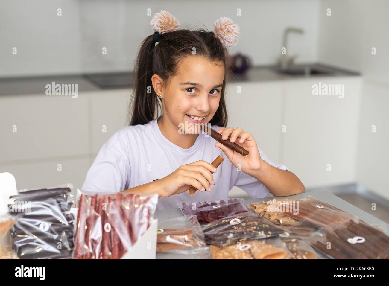 Little cute girl eating berry homemade paste candy Stock Photo - Alamy