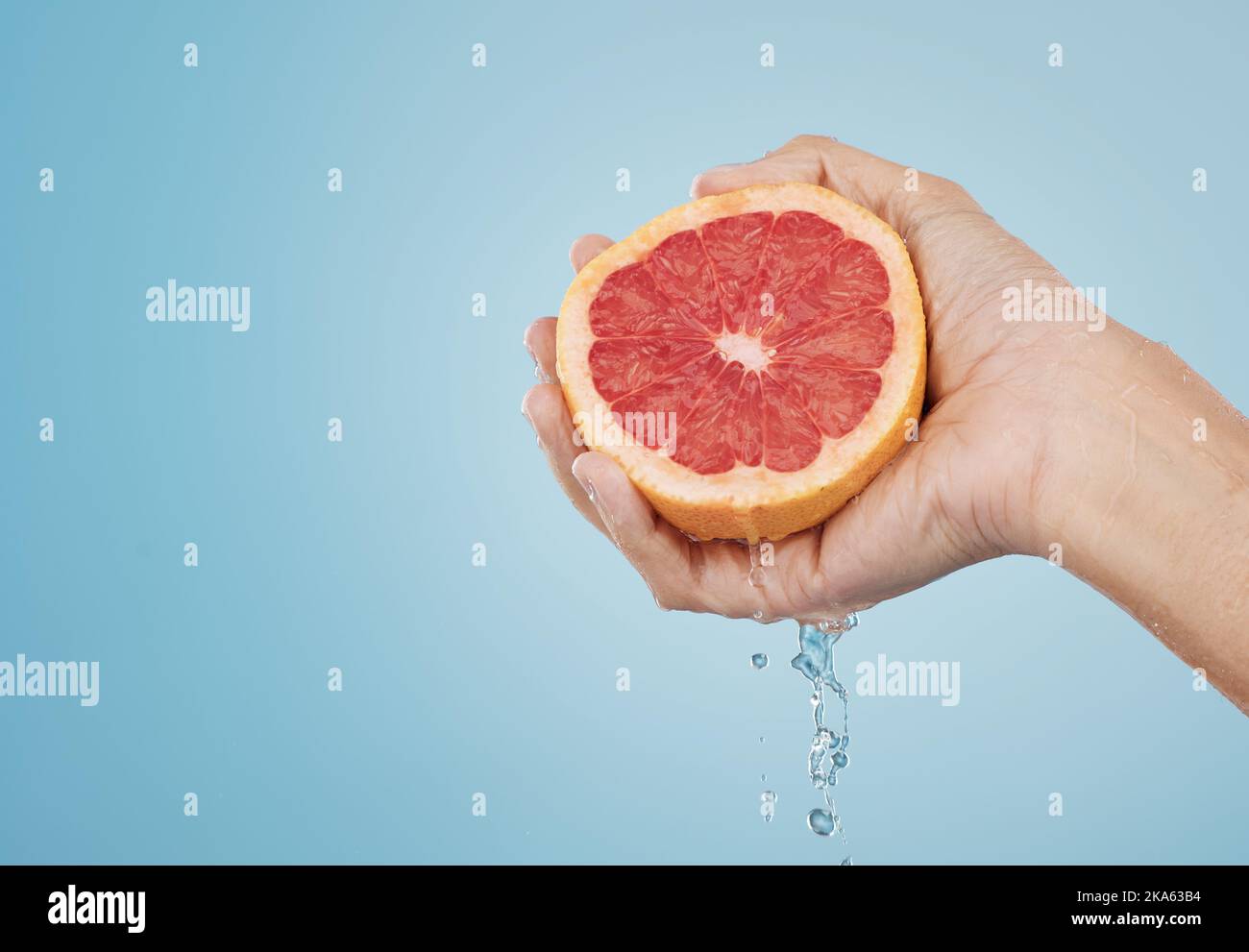 Grapefruit, food and wellness fruit juice of a woman hand with a ...