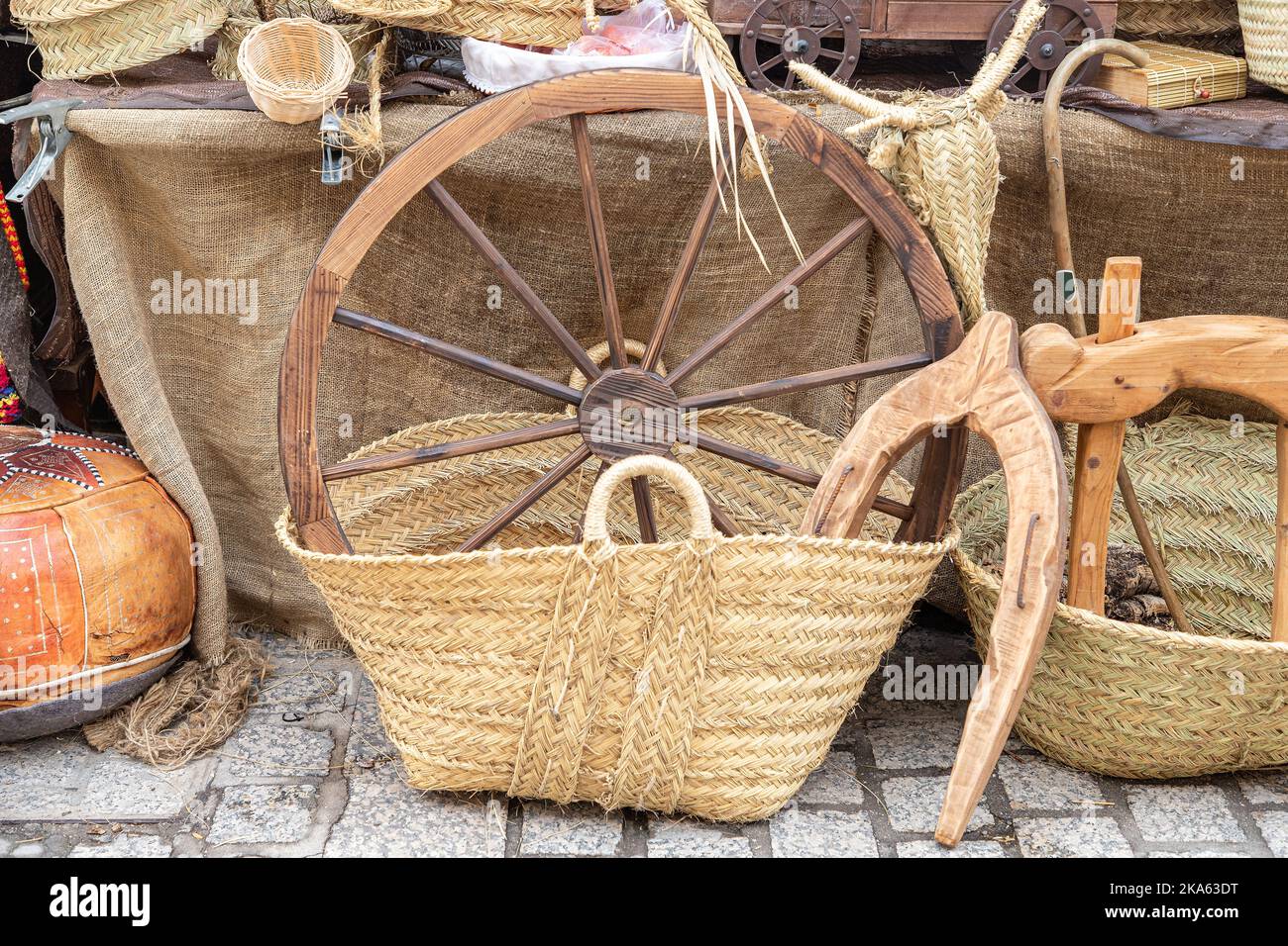 horizontal view in foreground of a wheel and wooden objects inside ...
