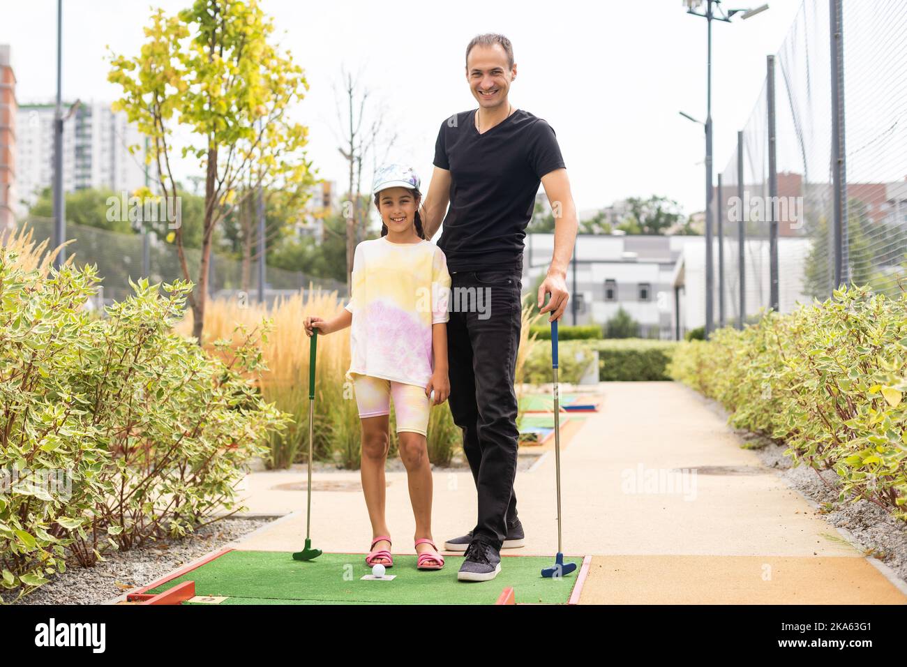 Family: Family Time Playing Mini-Golf In The Summer Stock Photo - Alamy