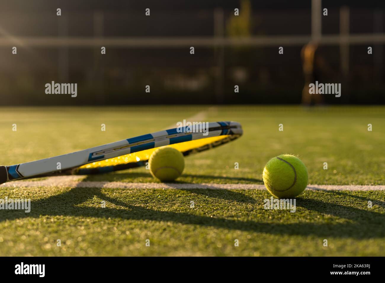 tennis balls and racket on the green grass background Stock Photo - Alamy