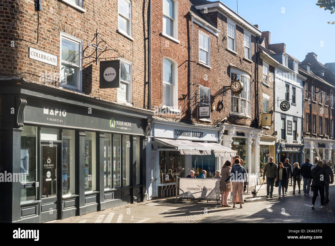 People walking along Colliergate in York city centre, North Yorkshire ...