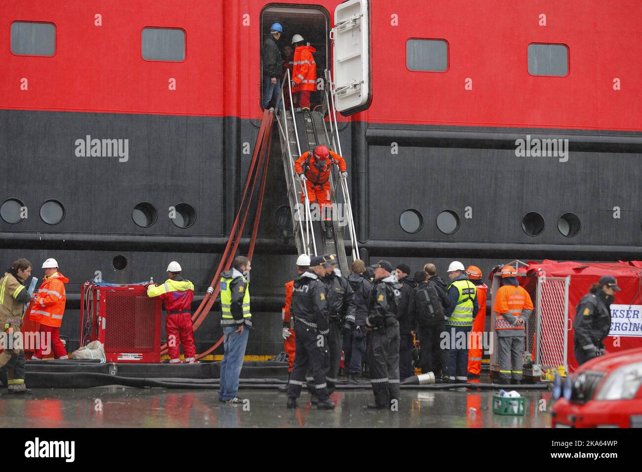 Firefighters are shown exiting the cruise ship MS Nordlys. Two people ...