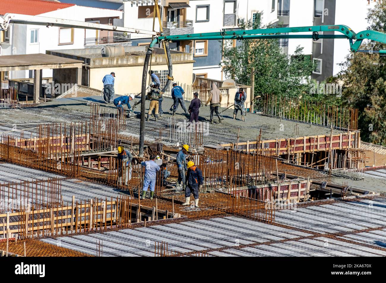 Pouring a Concrete Slab in a building construction site, with cranes ...
