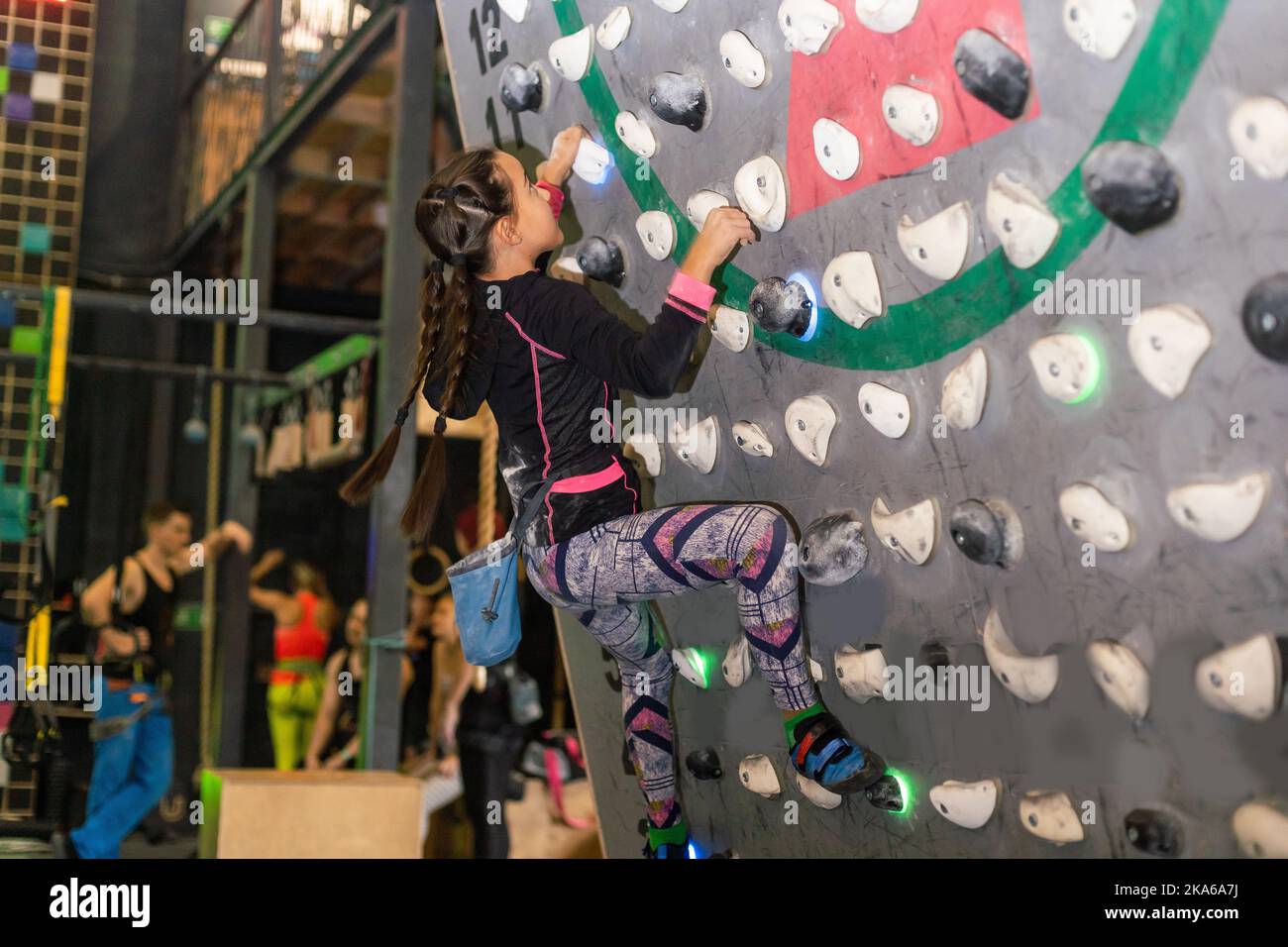 little girl climbing a rock wall indoor Stock Photo - Alamy
