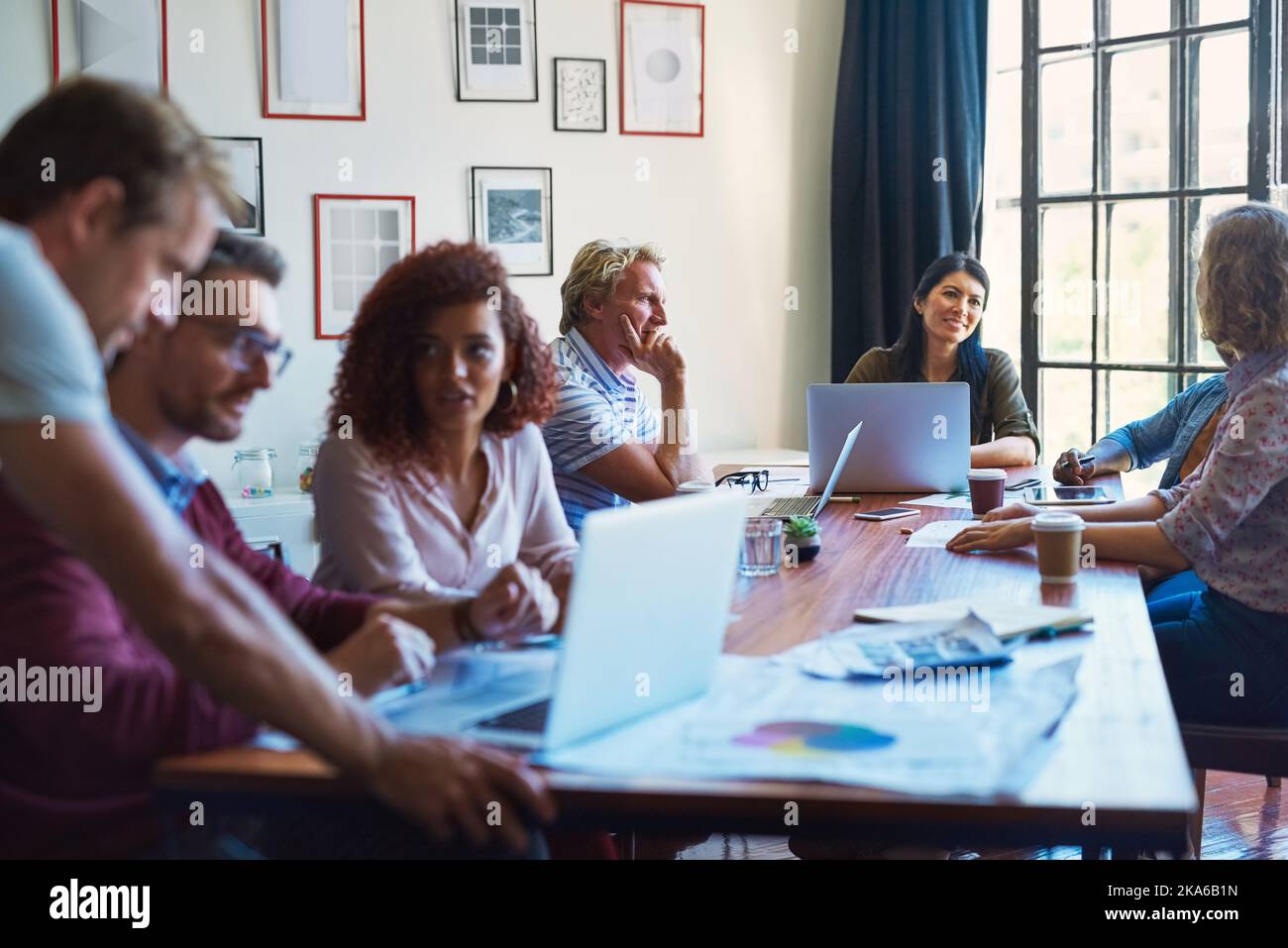 Chasing creative success as a team. a diverse group of businesspeople ...