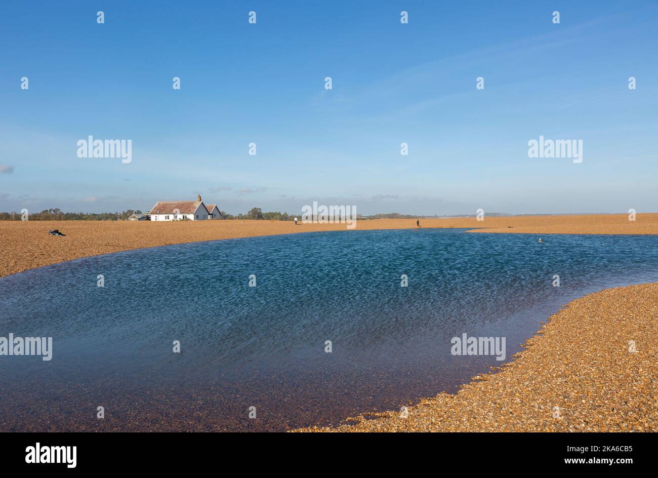 Lagoon of water used by swimmers on beach at Shingle Street, Suffolk ...