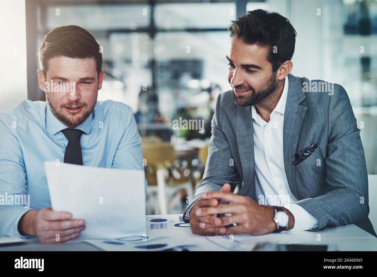 The numbers sure look promising. two young businessmen going through ...