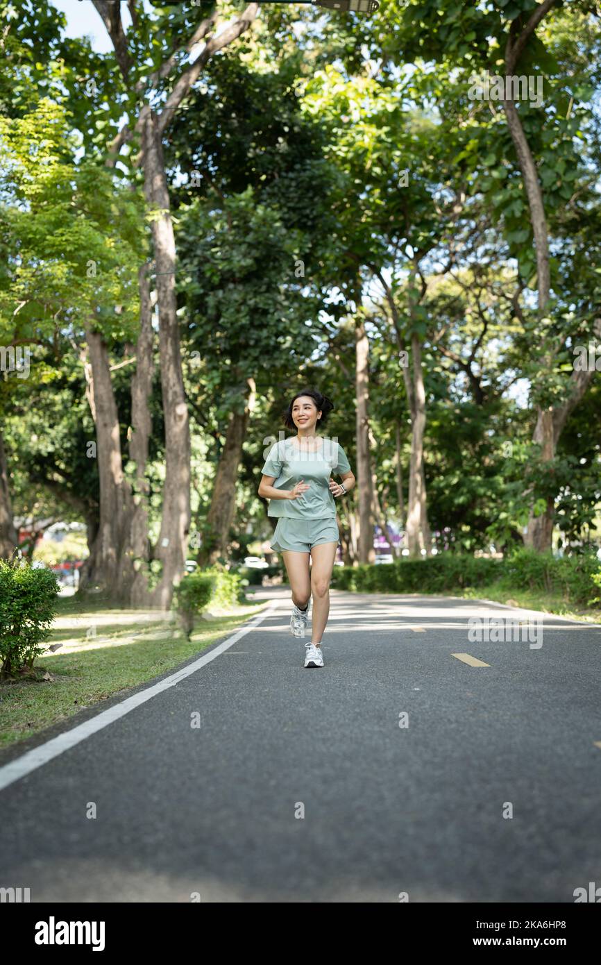 Portrait asian woman runners. She was running on the park in the ...