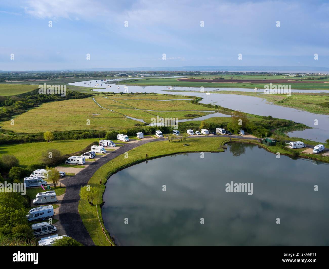 Motorhomes at the touring park at Uphill Marina with the River Axe ...
