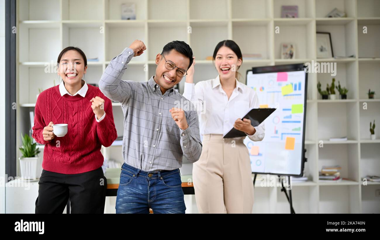 Group of overjoyed Asian businesspeople or startup workers celebrating ...