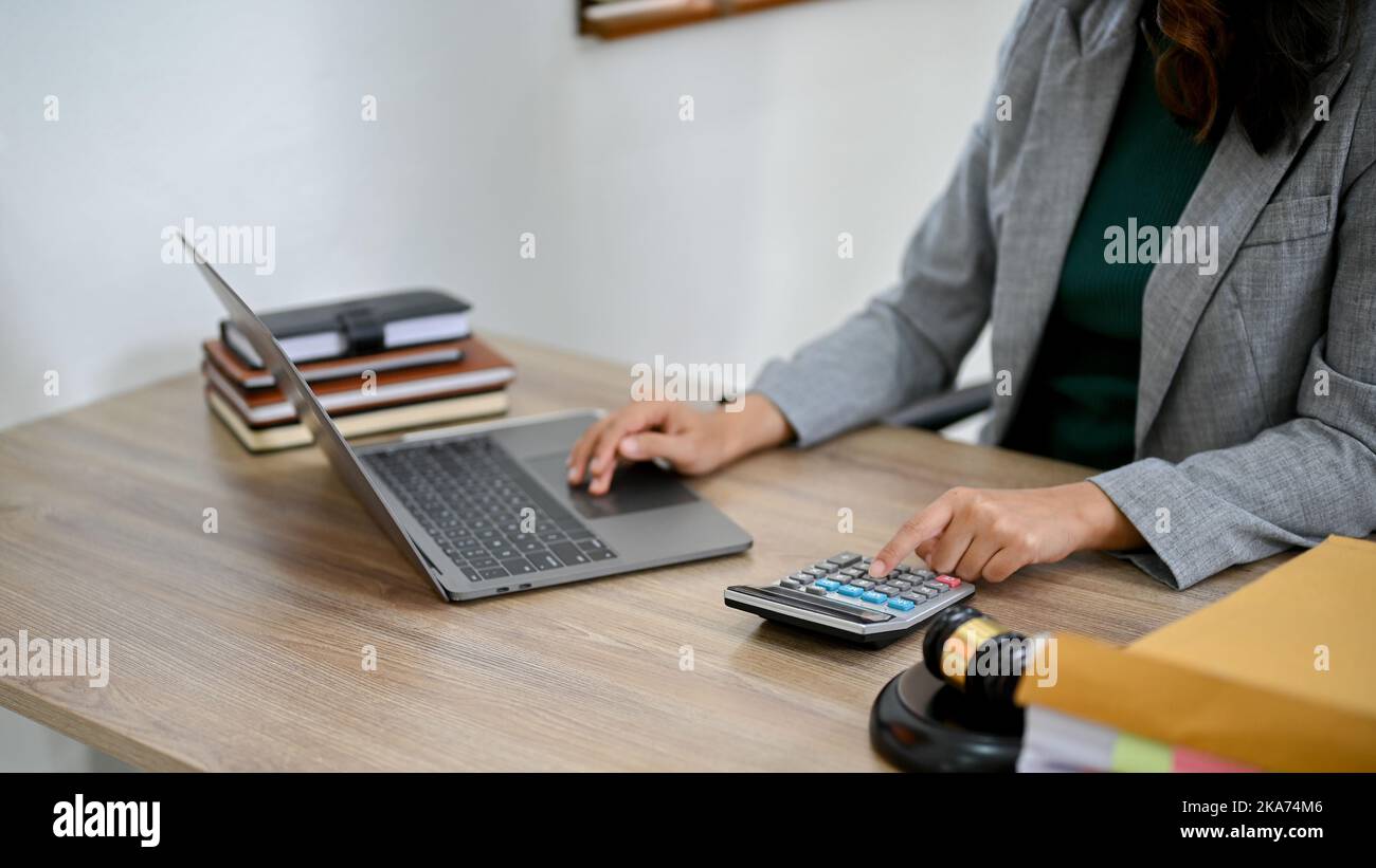 Professional Asian female lawyer working at her desk, using laptop ...