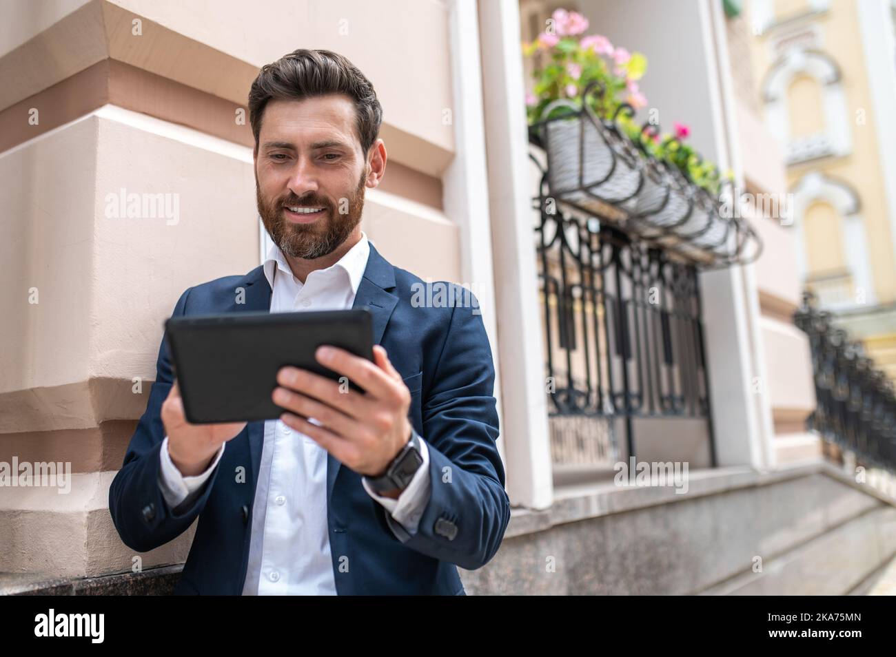 Man in a suit having a video call outside Stock Photo - Alamy