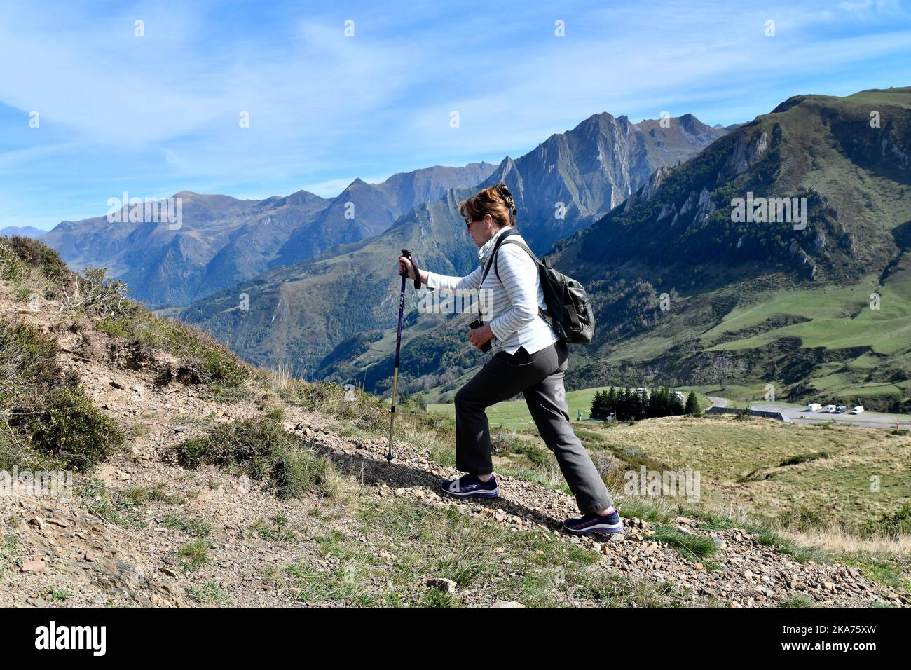 Woman walking on Col du Soulor in the pyrenees mountains bordering ...