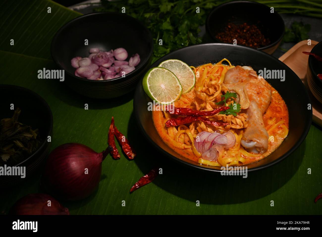 Delicious Thai curry noodles with chicken drumstick and vegetables or ...