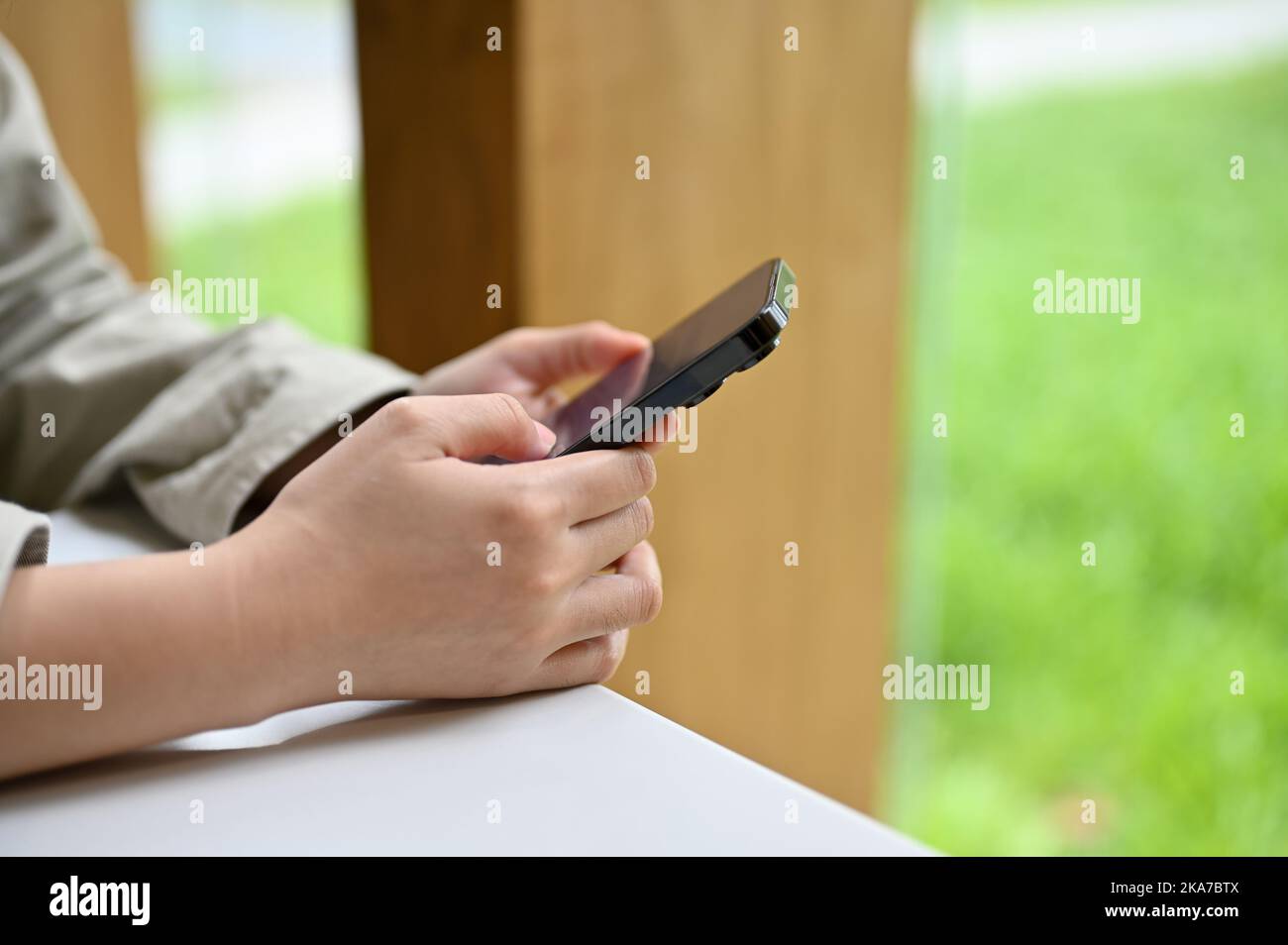 Close-up image, A female hands using a modern mobile phone at the table ...