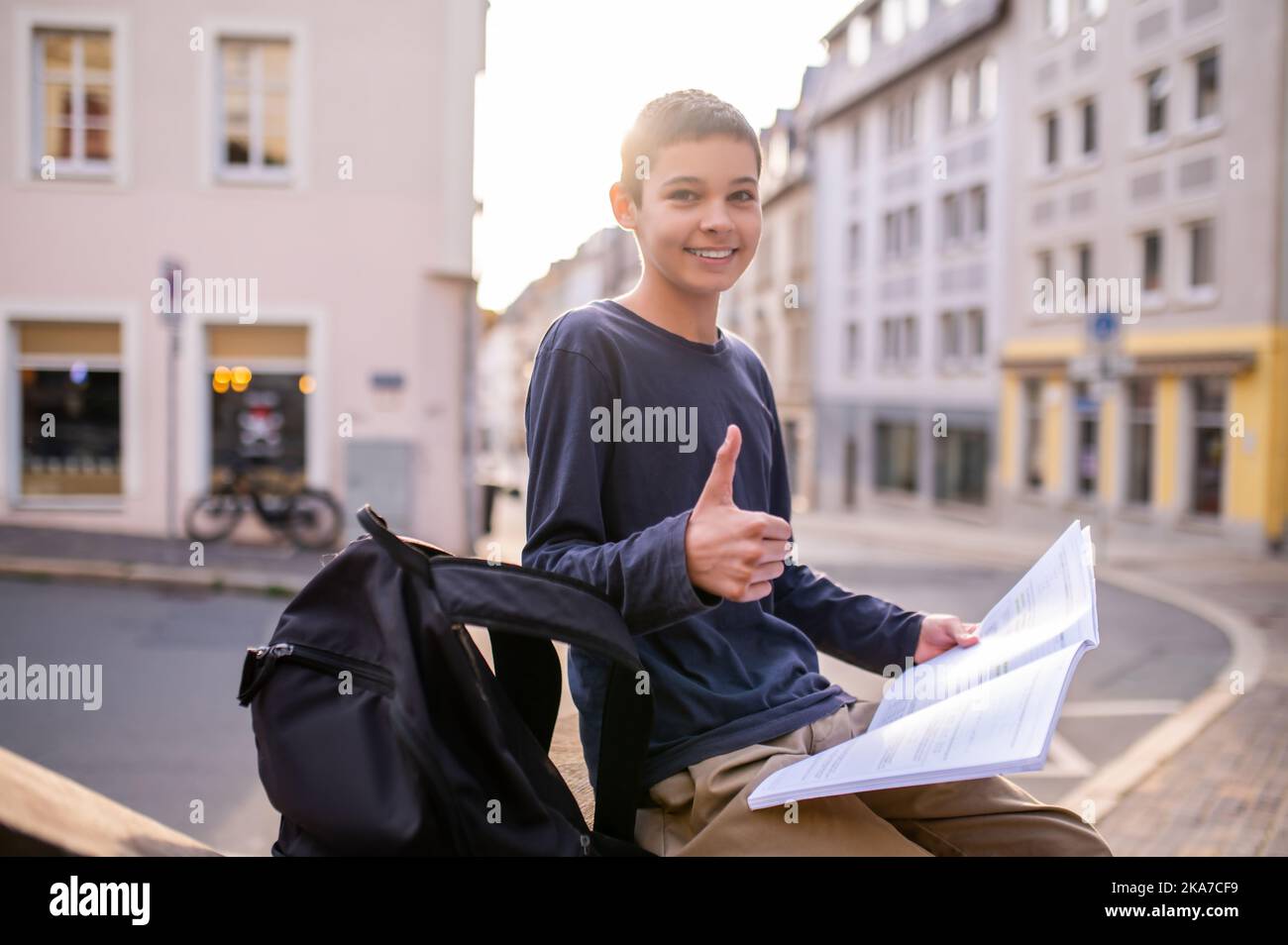 Smiling pleased boy approving the book before the camera Stock Photo ...