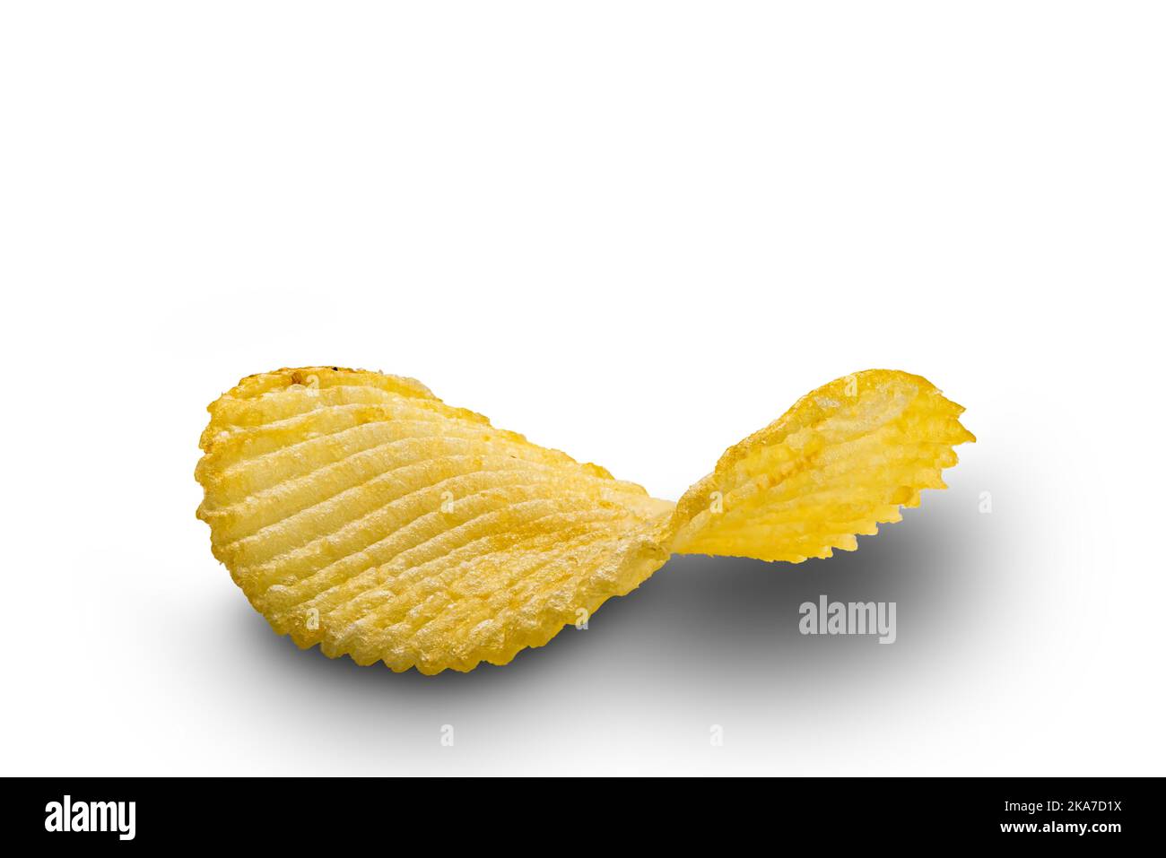 Closeup view of single corrugated dry crispy salted potato chip ...