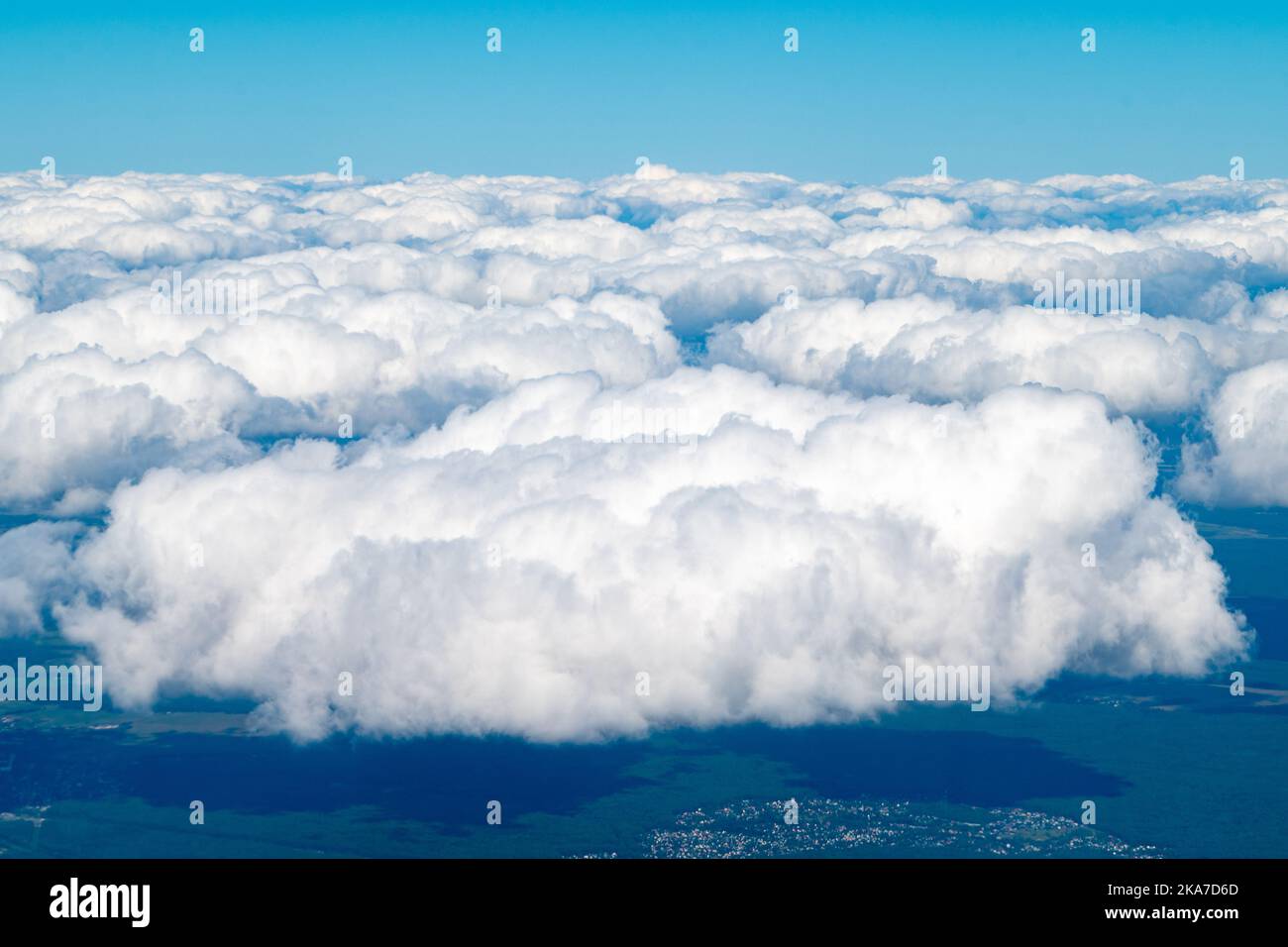 View of the white clouds in the blue sky from the window of the ...