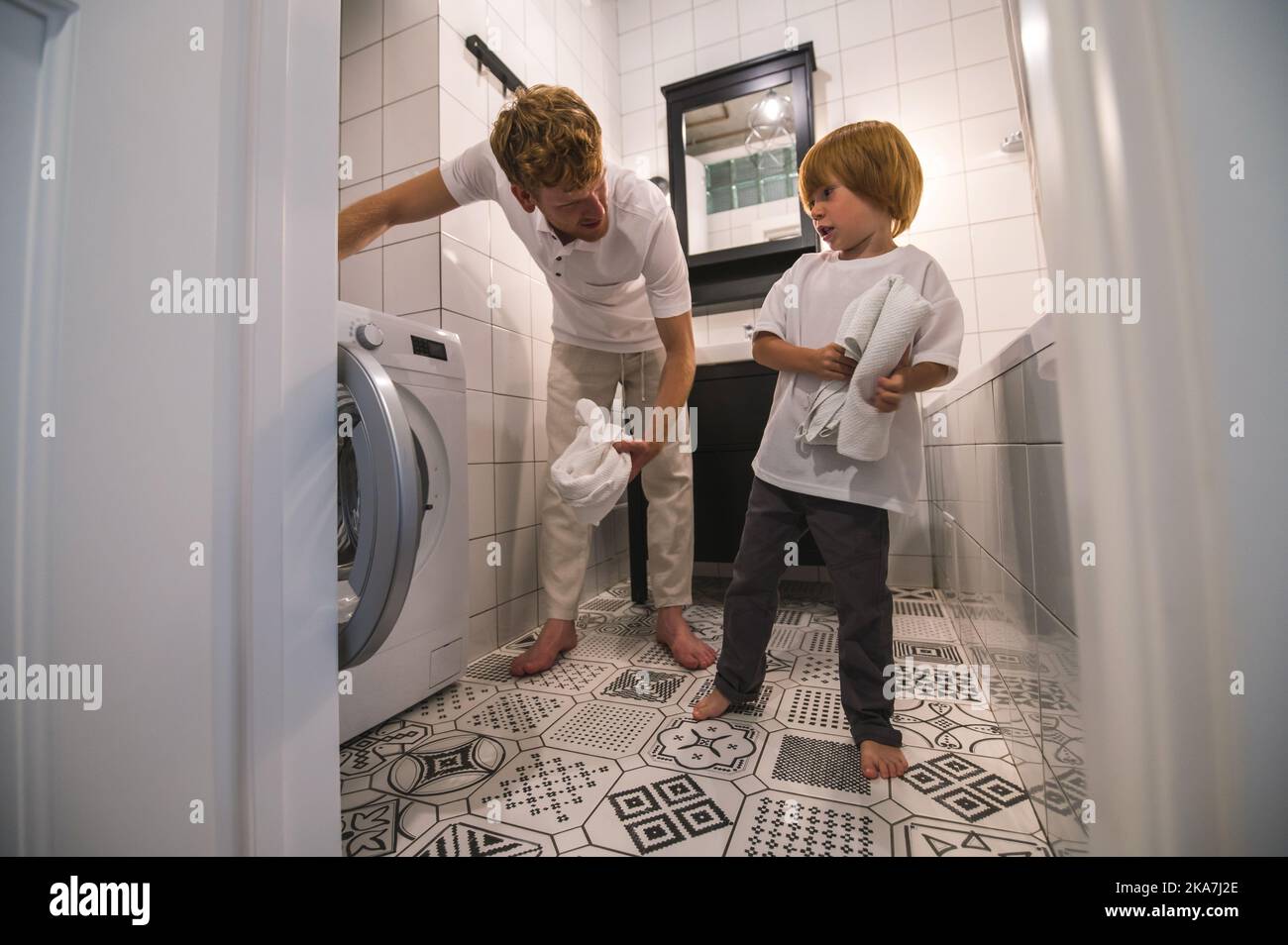 Dad and child with washing machine hi-res stock photography and images ...