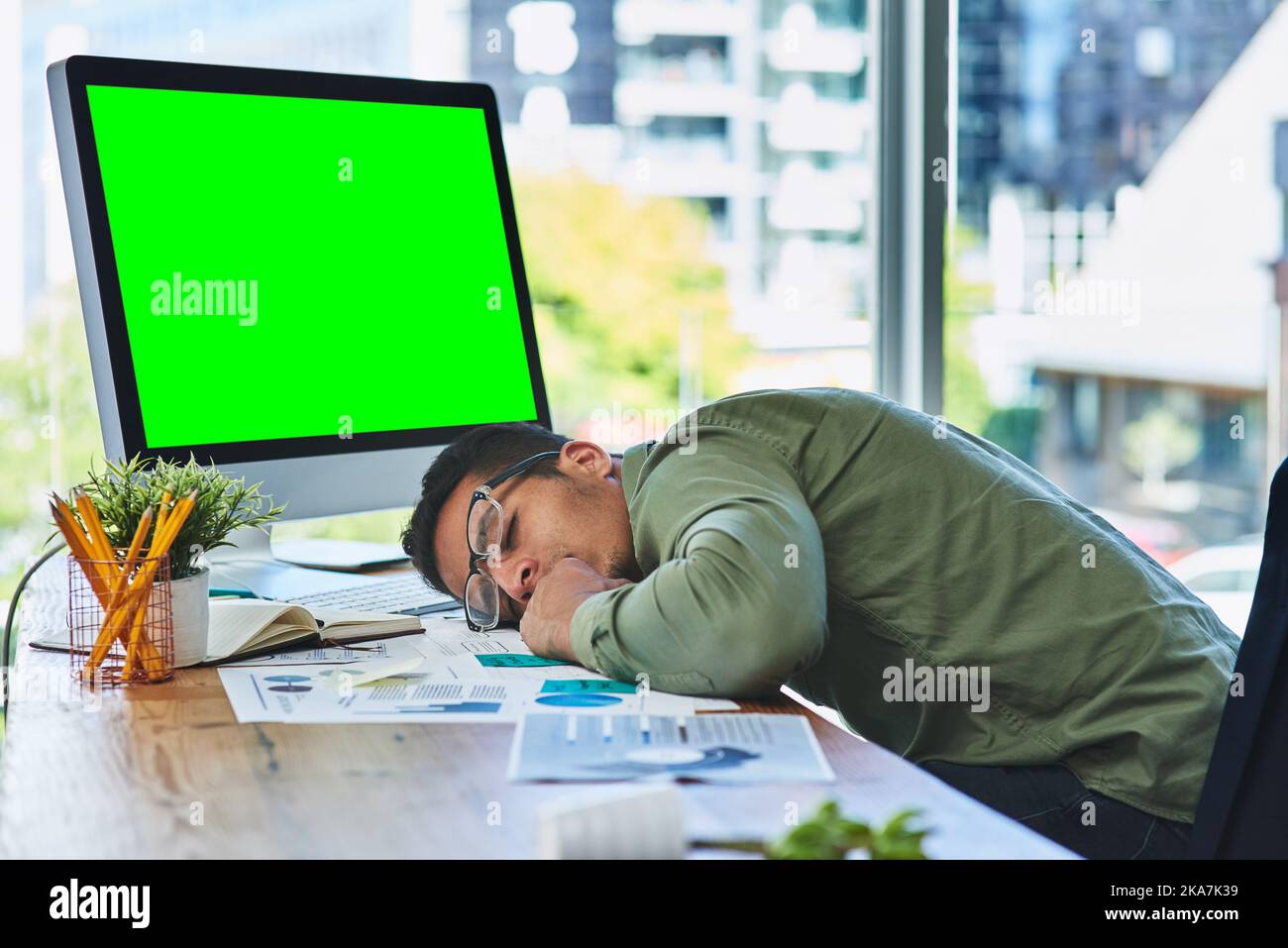 He works hard and sleeps hard too. a tired young businessman sleeping ...