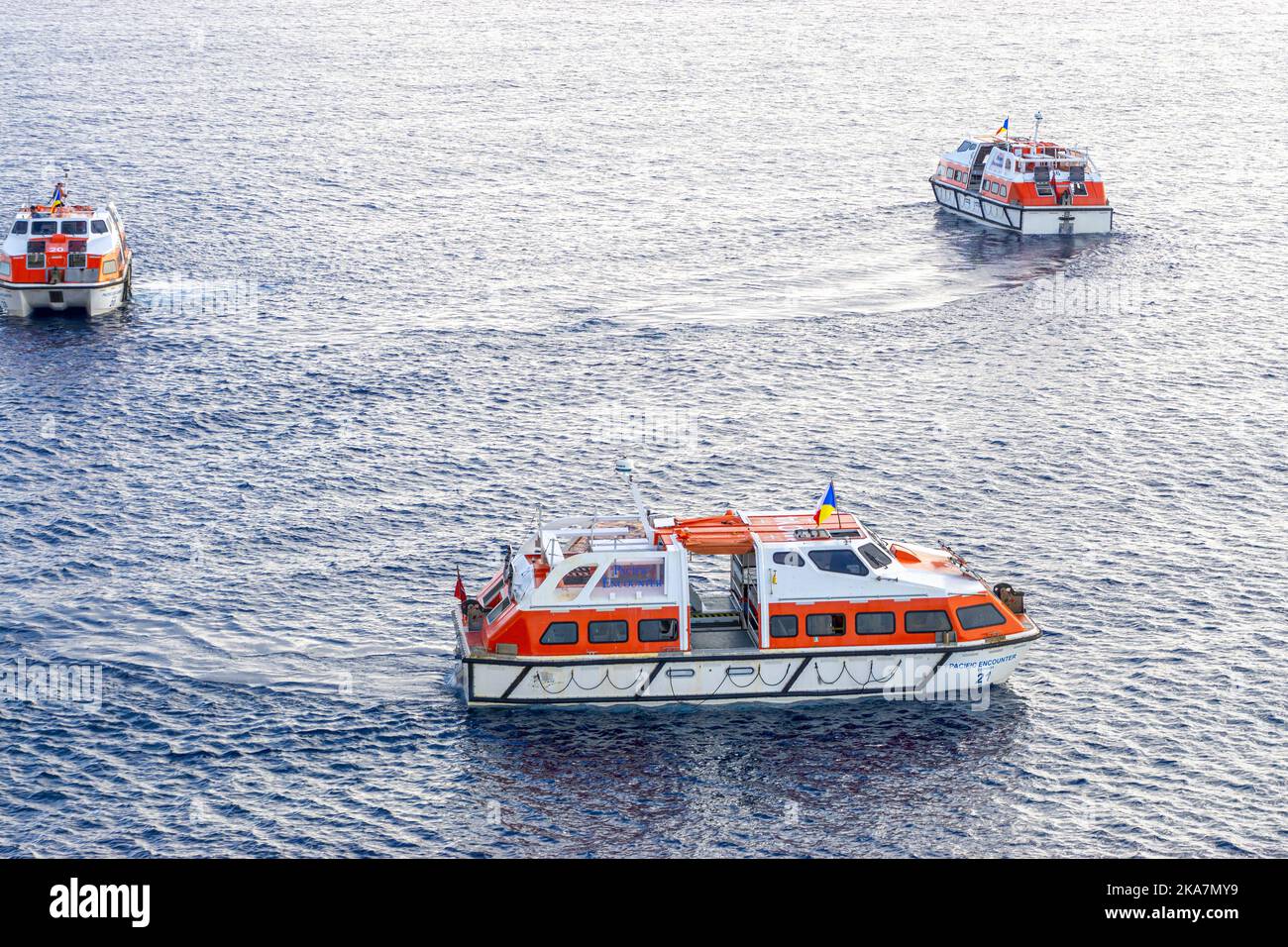 Passengers being transferred to jetty by small tenders from cruise ...